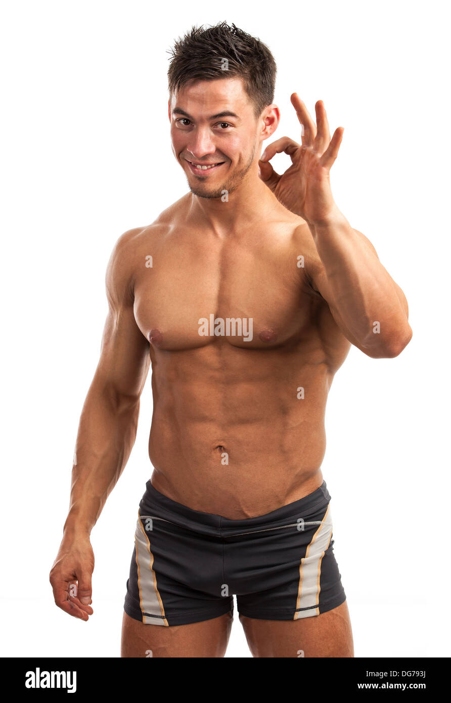 Muscular young man showing the ok sign isolated over white Stock Photo ...