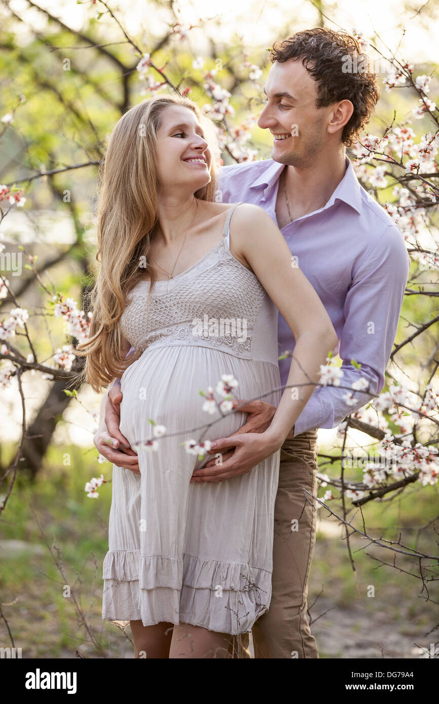 Young pregnant couple outdoors in spring Stock Photo - Alamy