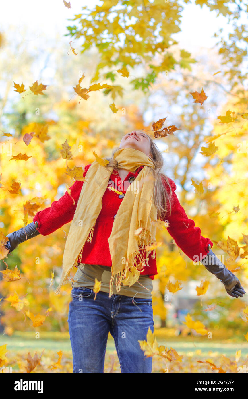 Woman throwing leaves in the air hi-res stock photography and images ...