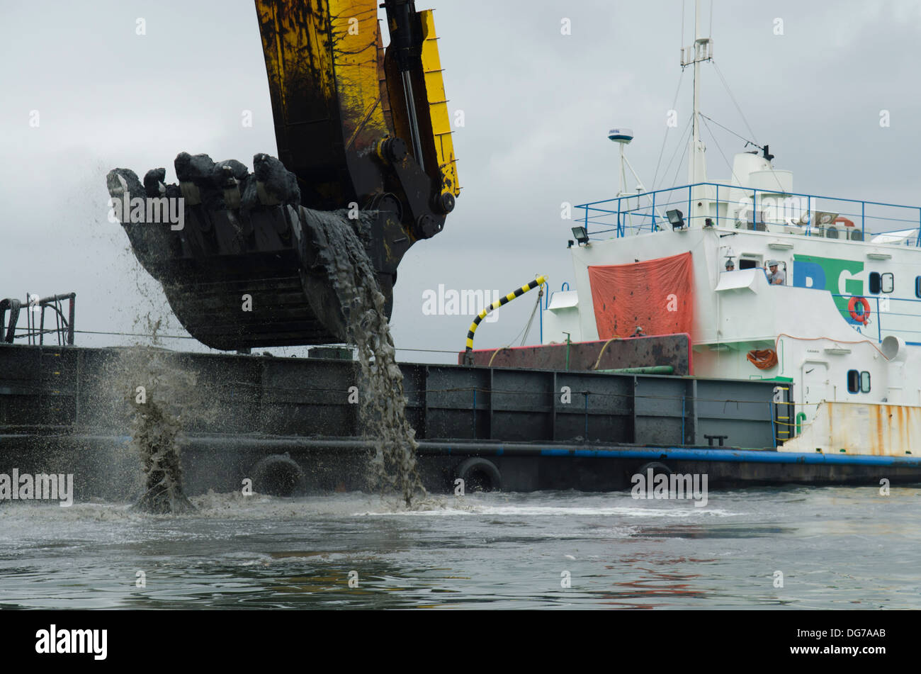dredger ship digging at Santos (Sao Paulo, Brazil) port channel to make ...