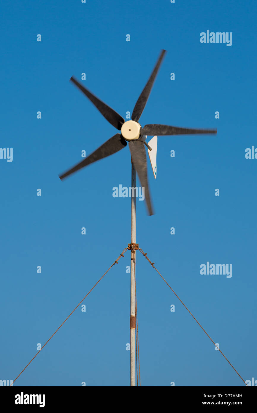 Moving propeller from a little wind turbine in the clear blue sky of ...