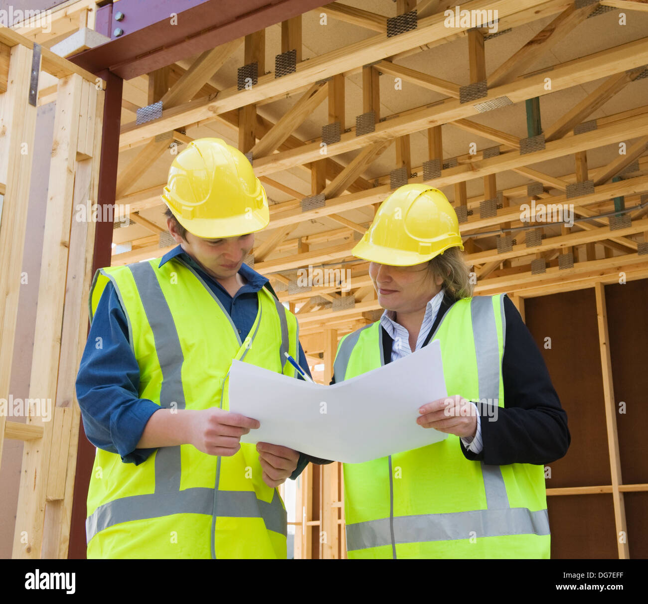 civil engineer and worker discussing issues at the construction site ...