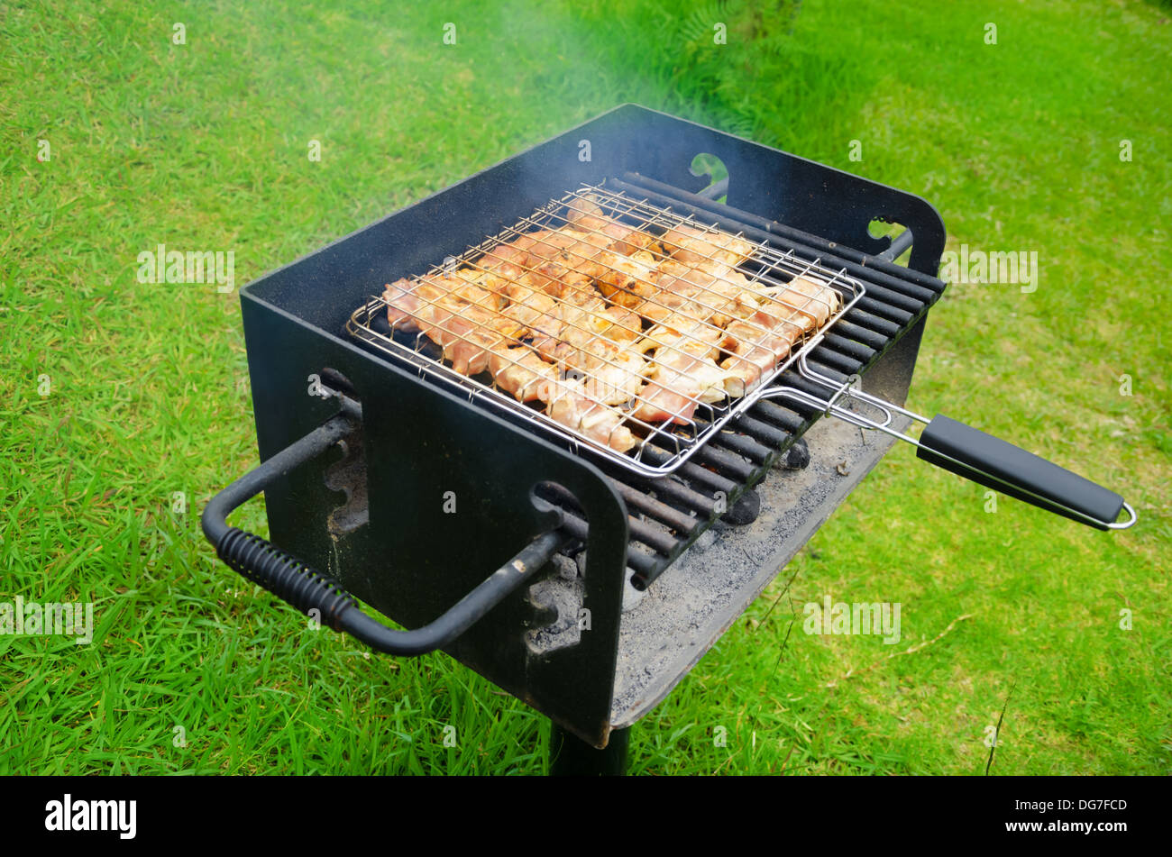 Fresh meat preparing on grill in summer day Stock Photo - Alamy