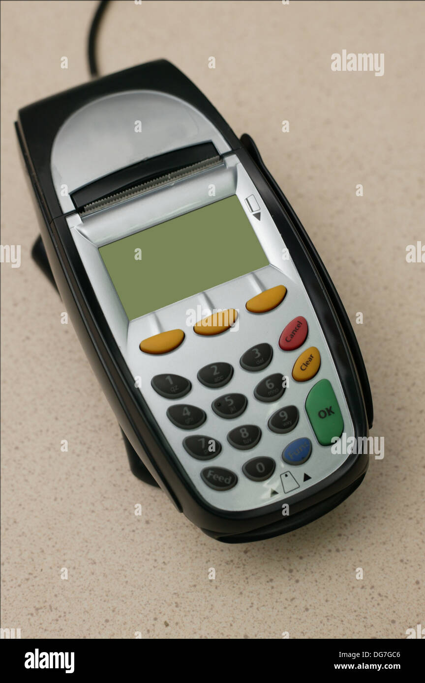 A eftpos machine on a plain background Stock Photo - Alamy
