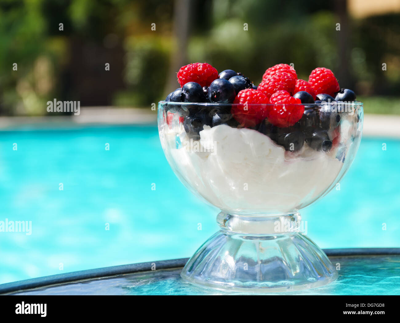 Morning dessert with fresh berries by the swimming pool Stock Photo - Alamy