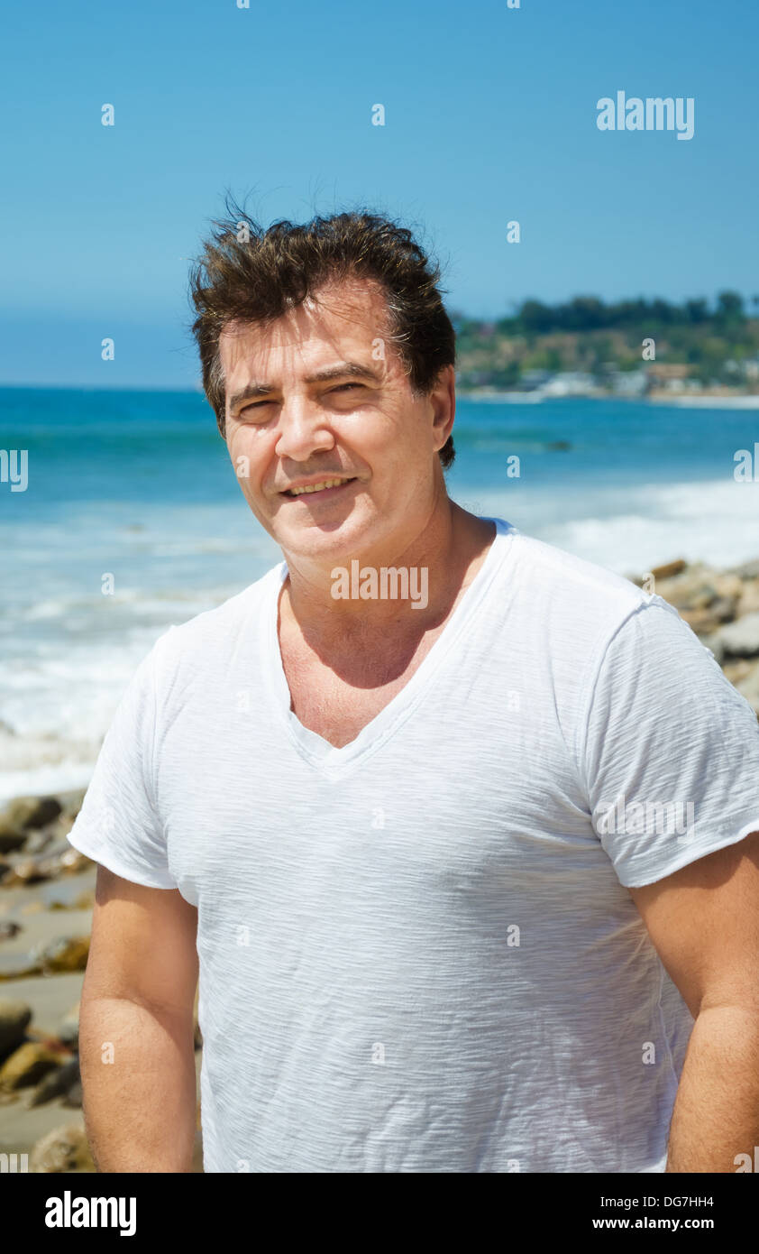 Portrait of a happy greek man on beach Stock Photo - Alamy
