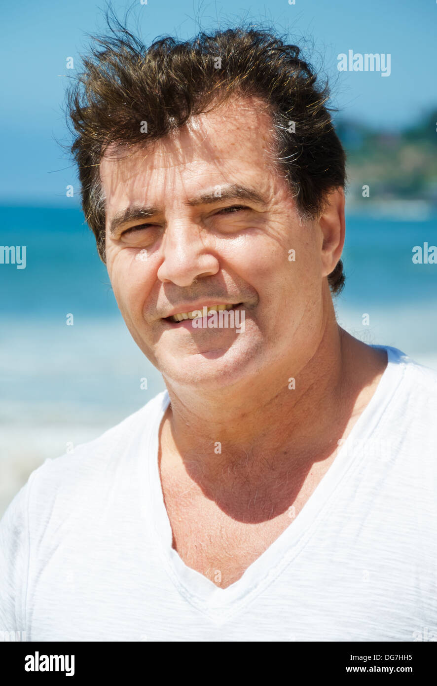 Portrait of a happy greek man on beach Stock Photo - Alamy