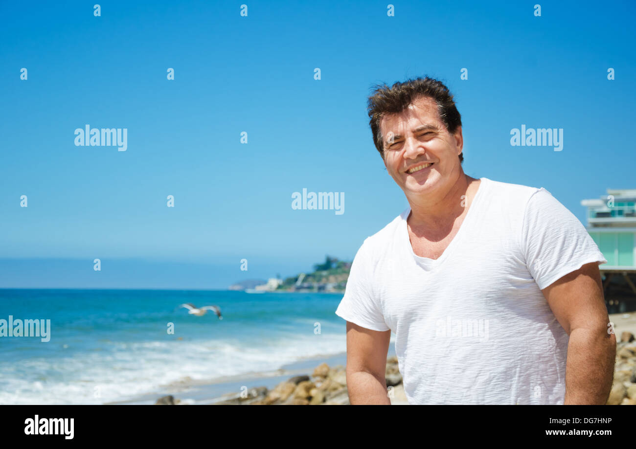 Portrait of a happy greek man on beach Stock Photo - Alamy