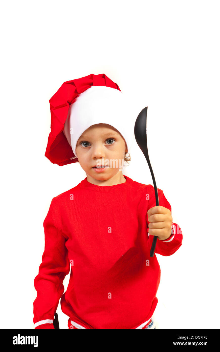 Toddler chef boy showing big black spoon isolated on white background ...
