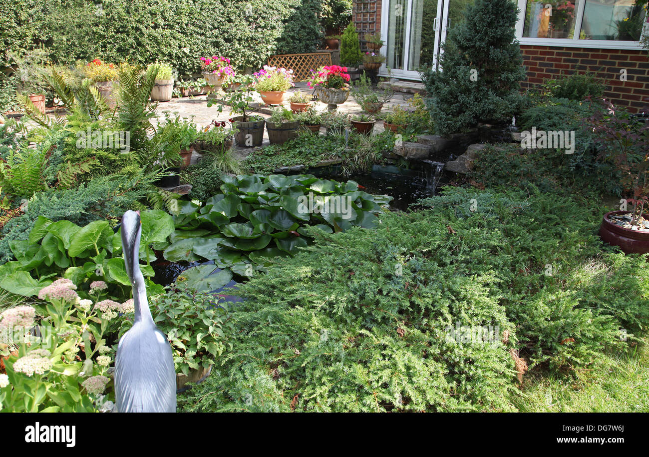 Plastic heron guarding a garden pond Stock Photo - Alamy
