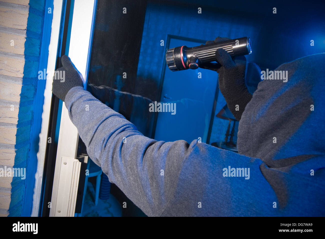 A burglar is opening the back door of a house Stock Photo - Alamy