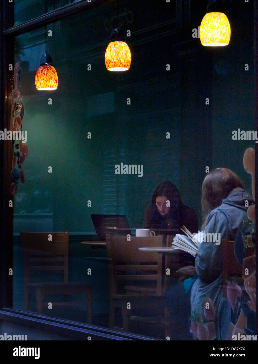 Reading in a coffee bar Stock Photo - Alamy