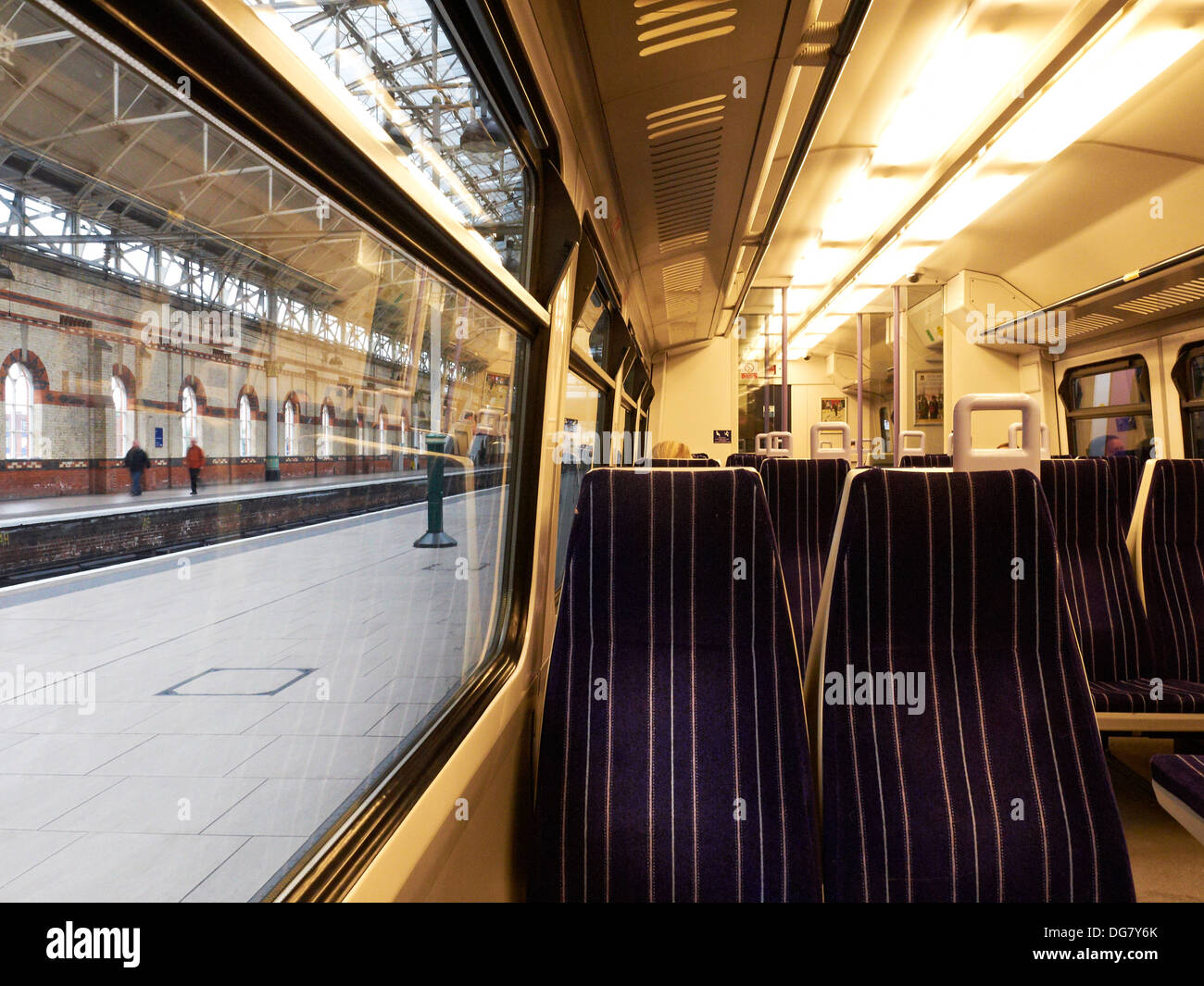 Inside a train looking out over platform at Piccadilly station ...