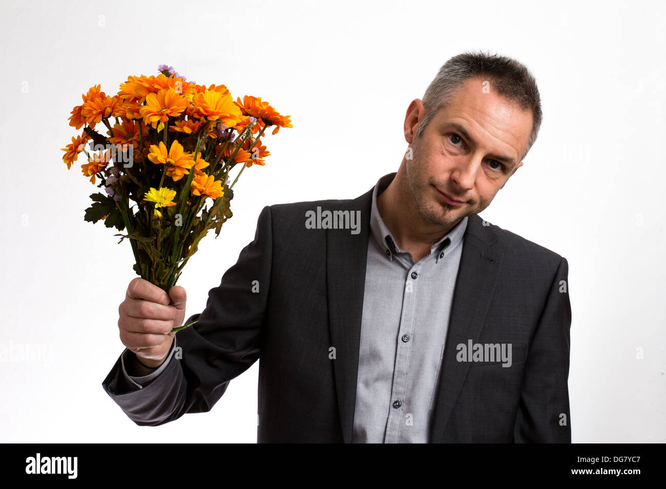 Sad man with bunch of flowers, looking dejected Stock Photo - Alamy