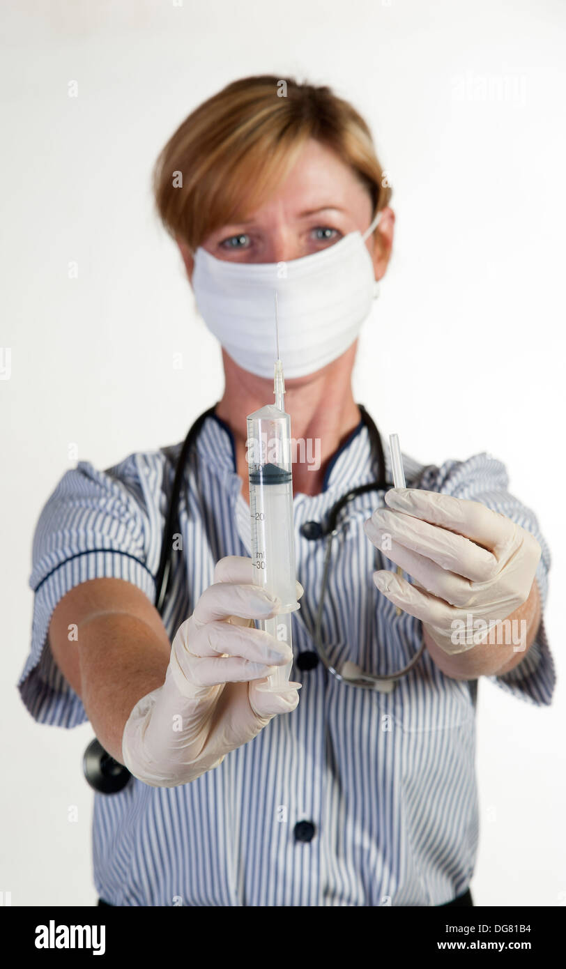 Nurse holding a syringe and wearing rubber surgical gloves Stock Photo ...