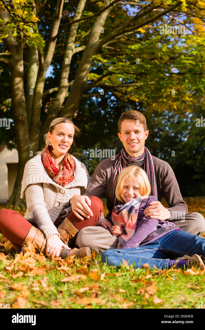 Happy family, Mother, father and daughter or child sitting outdoor on ...