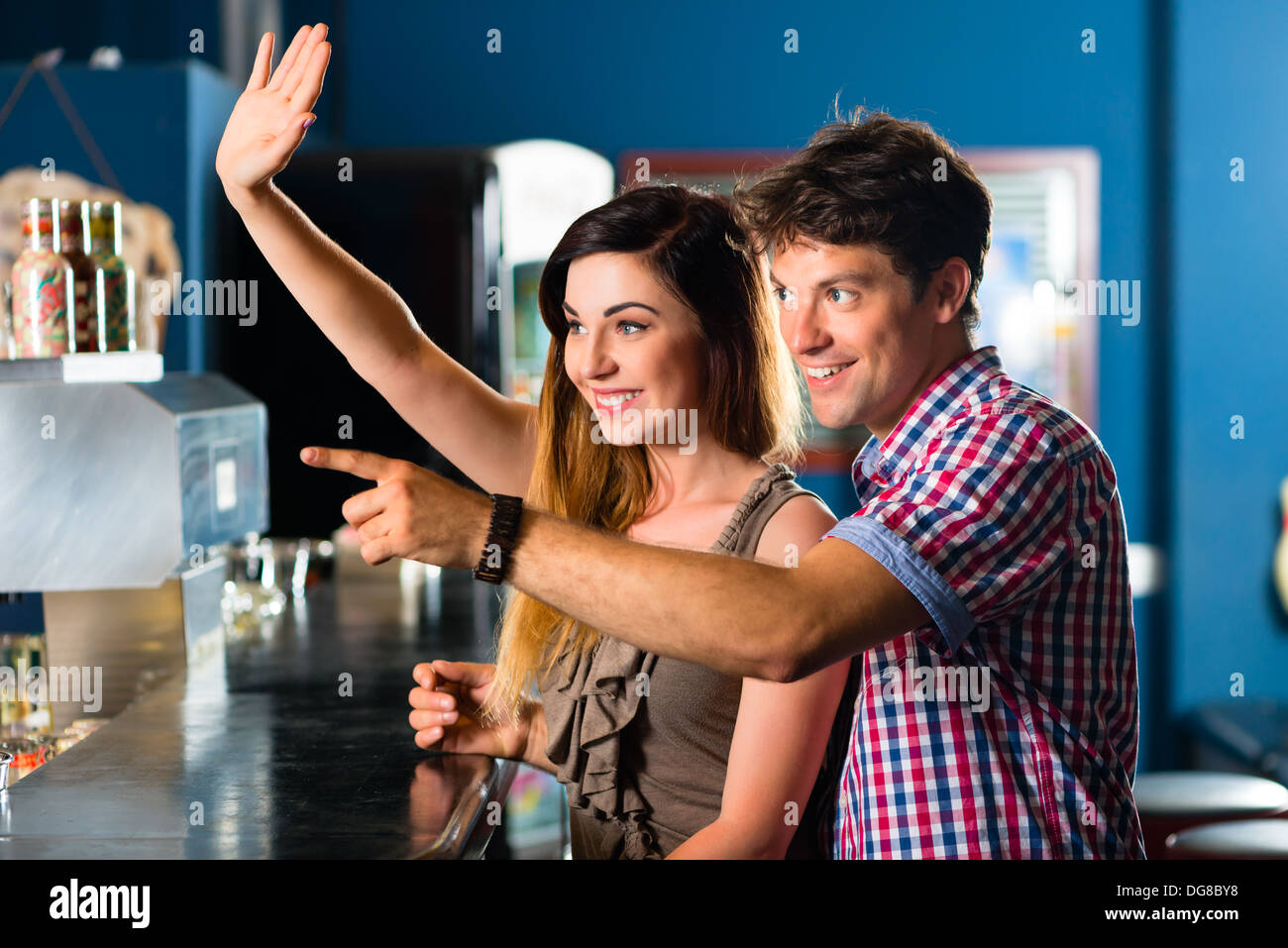 Young people or couple having a date in a club or a bar Stock Photo - Alamy