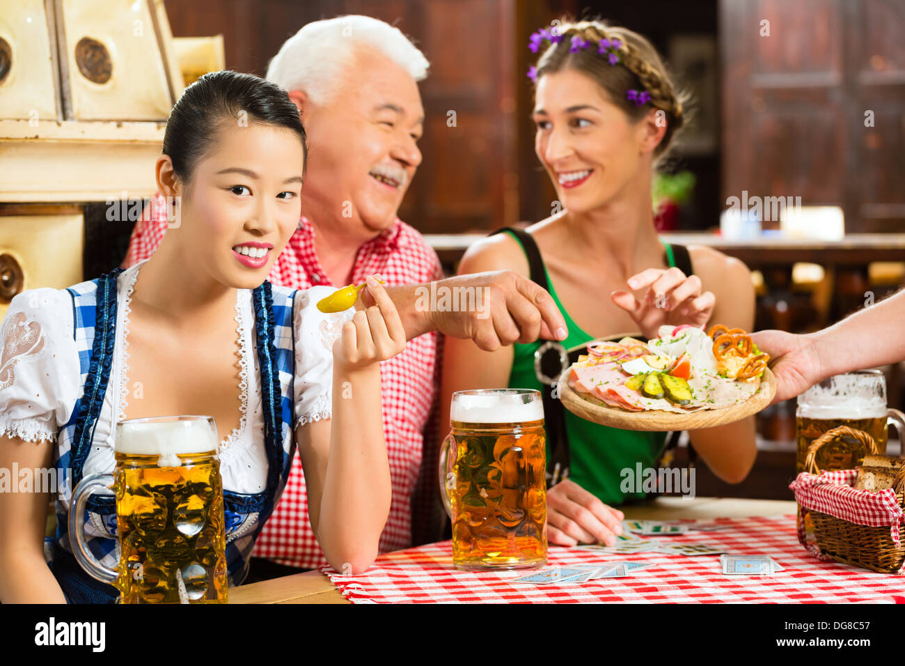 Mature woman with friends eating in pub hi-res stock photography and ...