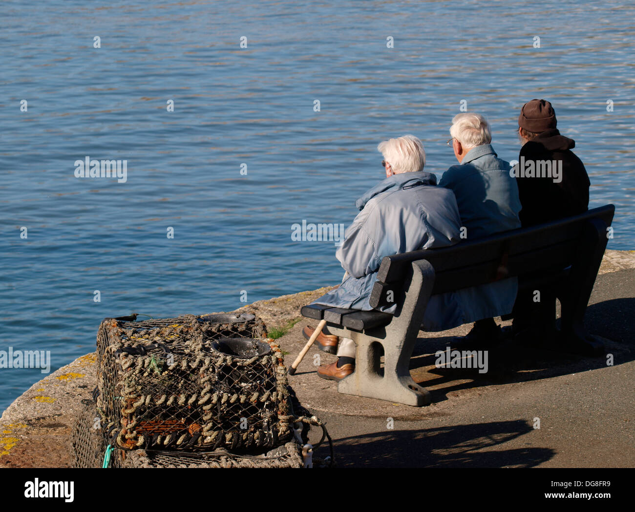 Three old men sat on a bench at the seaside, Bude, Cornwall, UK Stock ...