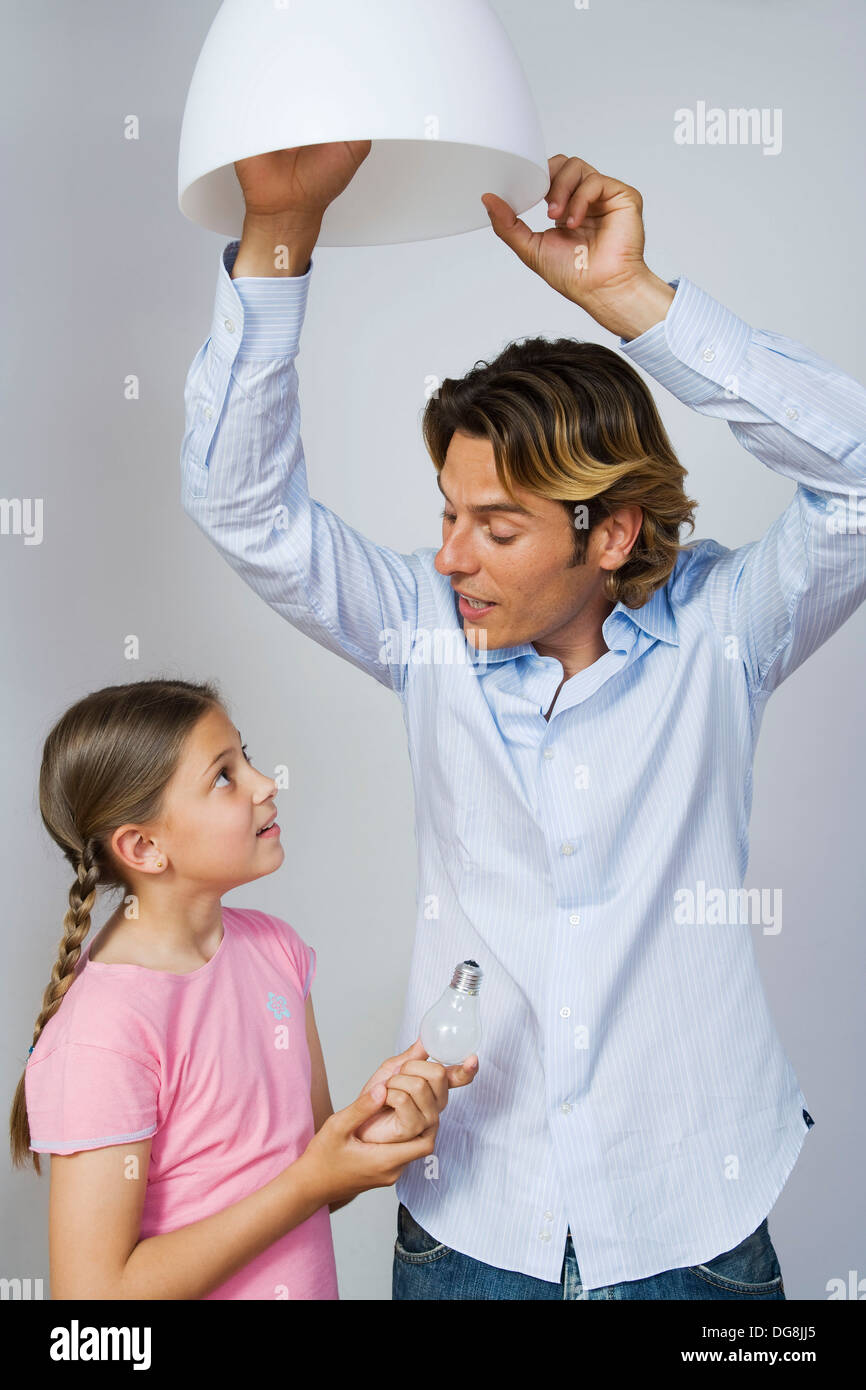Child changing lightbulb hi-res stock photography and images - Alamy