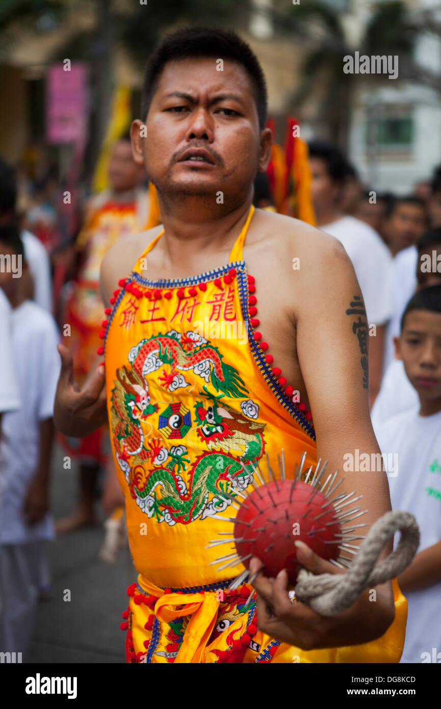 A Spirit medium walks in a street procession at the Phuket Vegetarian ...