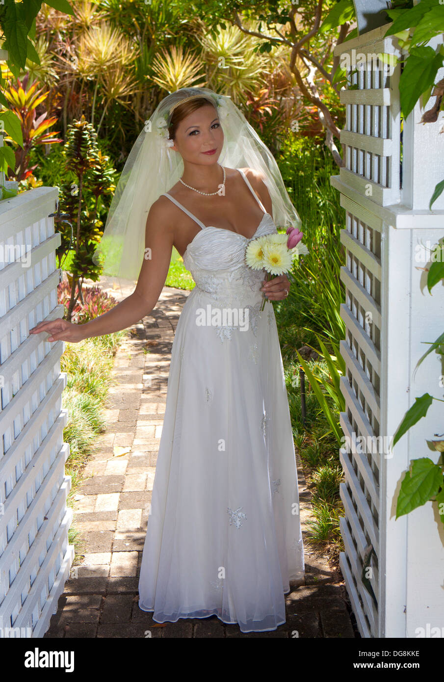 Bride in a garden on her wedding day Stock Photo - Alamy