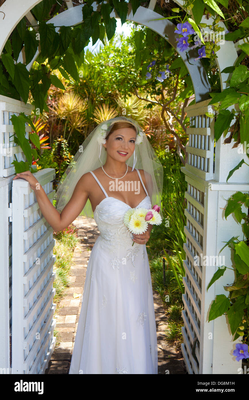 Bride in a garden on her wedding day Stock Photo - Alamy