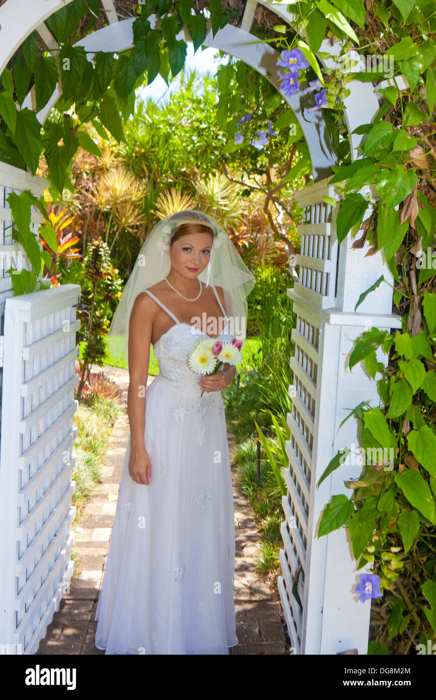 Bride in a garden on her wedding day Stock Photo - Alamy