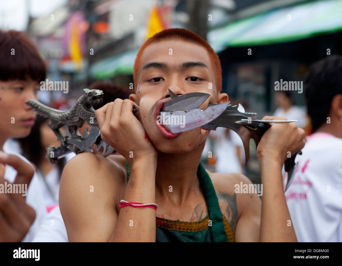 A Spirit medium walks in a street procession at the Phuket Vegetarian ...