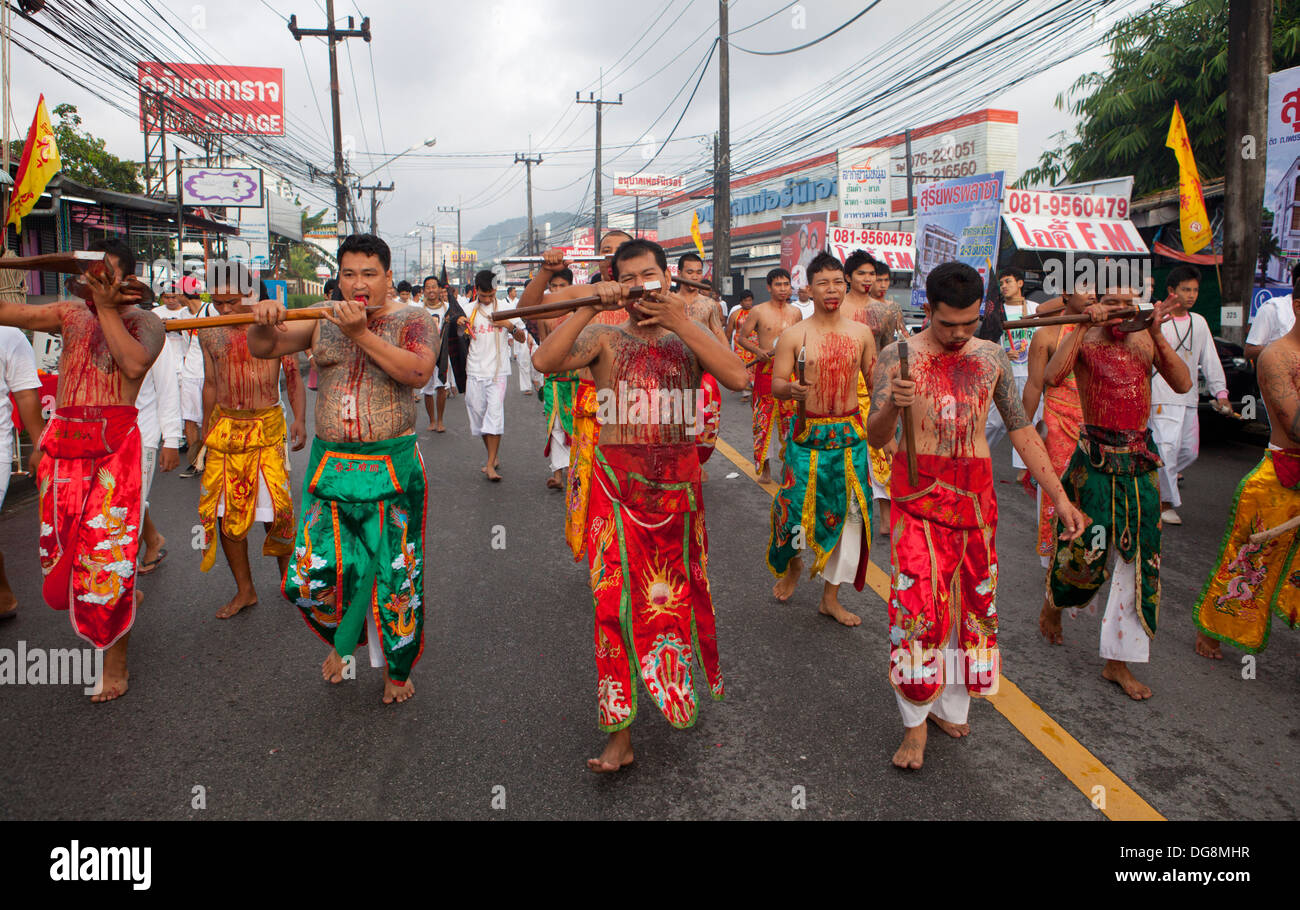A Spirit medium walks in a street procession at the Phuket Vegetarian ...