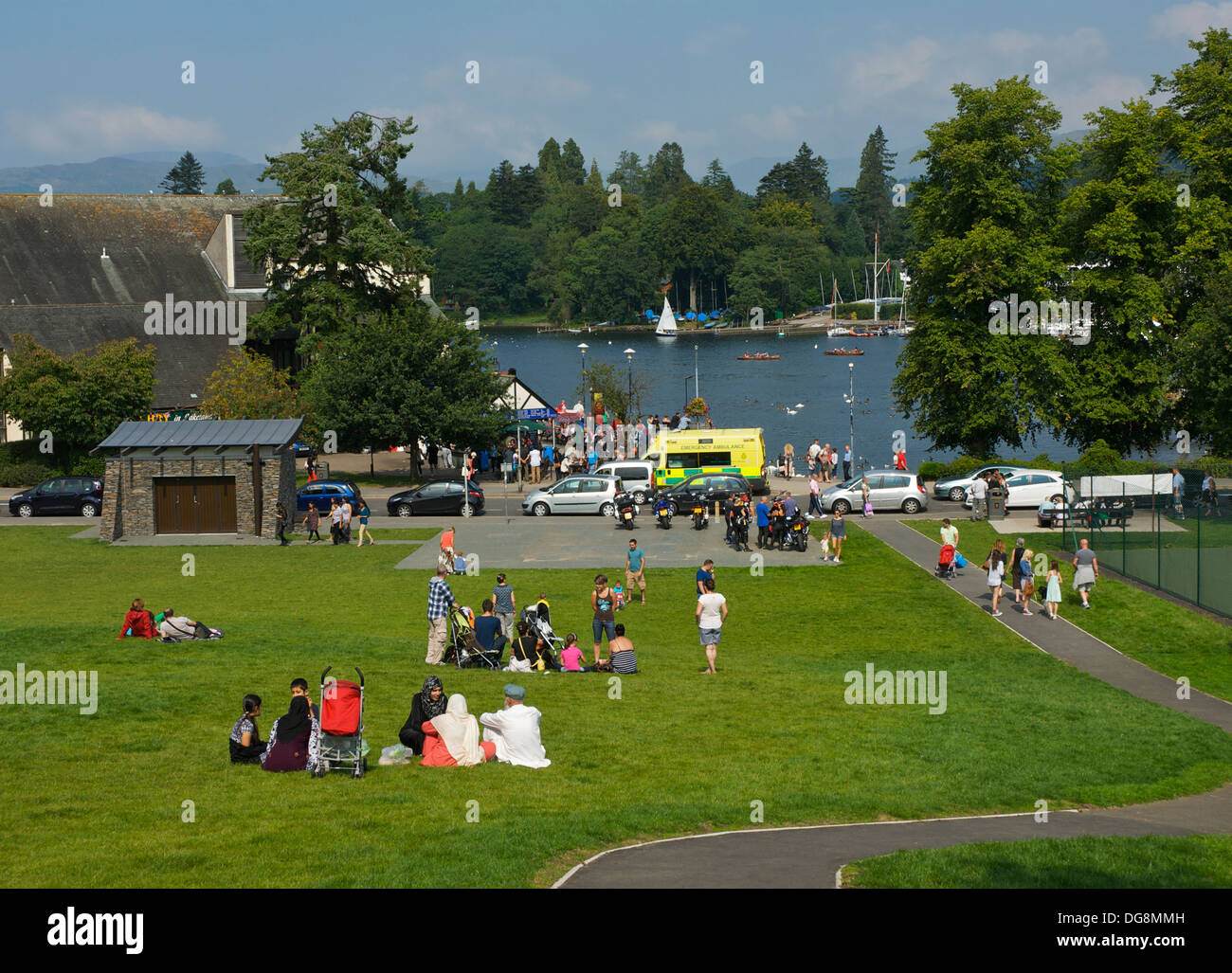 Visitors relaxing on the Glebe, a park in Bowness, Lake District ...