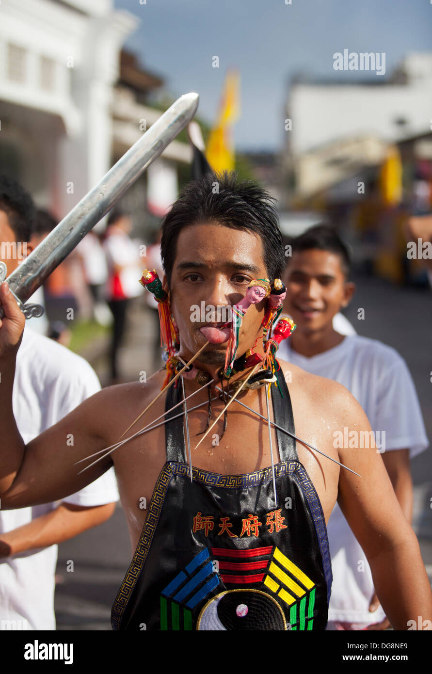 A Spirit medium walks in a street procession at the Phuket Vegetarian ...