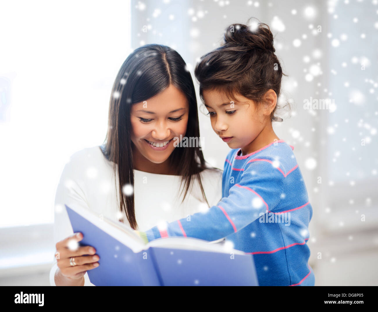 mother and daughter with book Stock Photo - Alamy