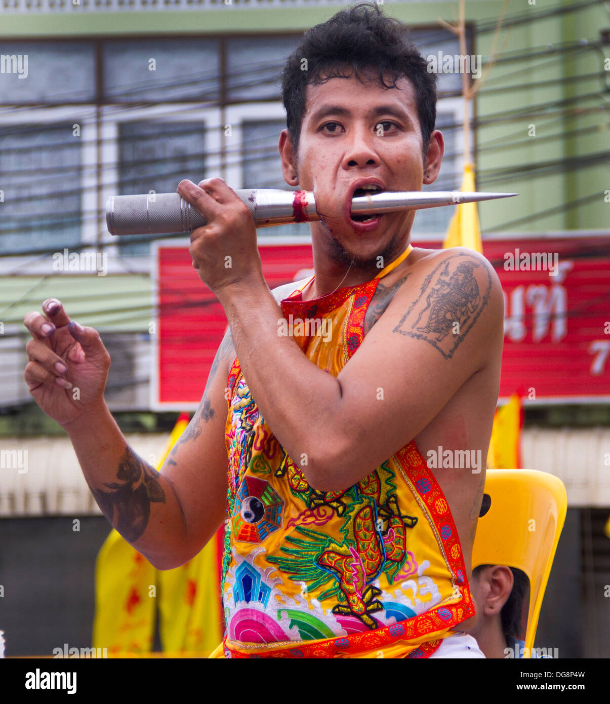 A Spirit medium walks in a street procession at the Phuket Vegetarian ...