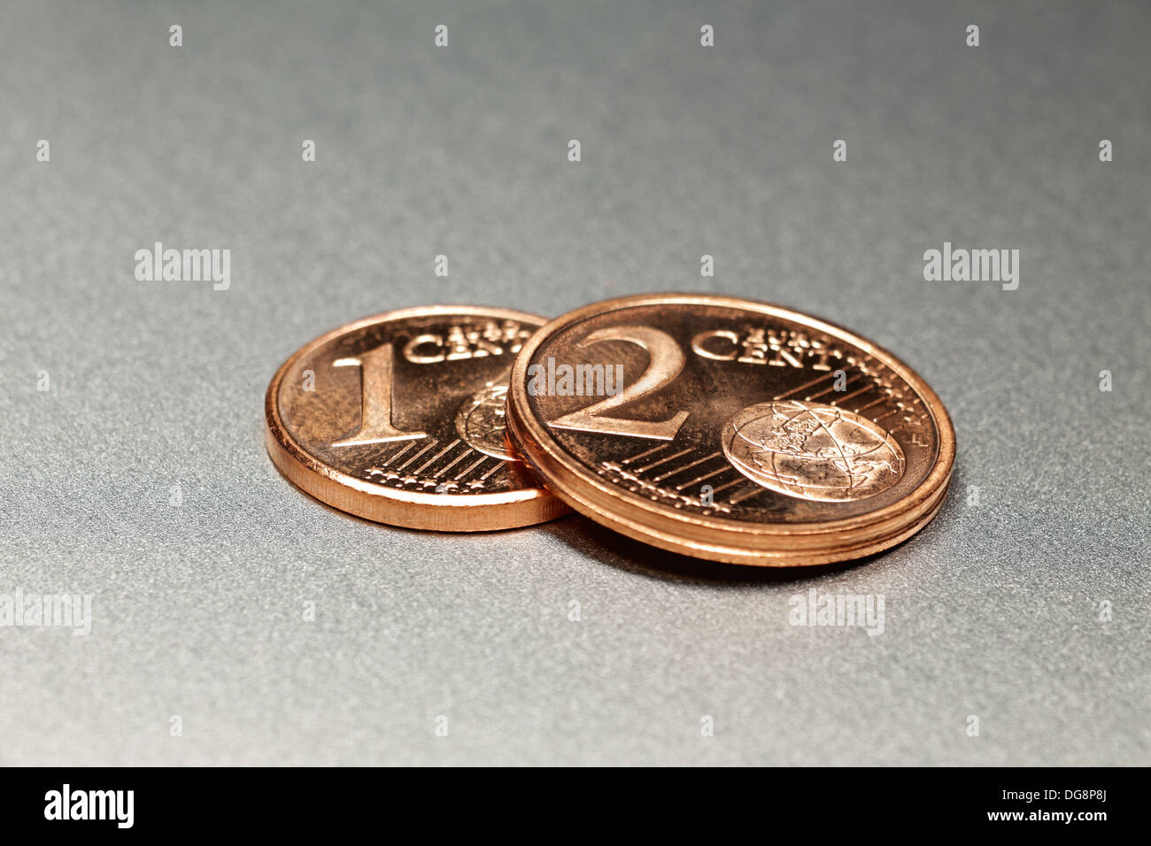 1 Euro Cent and 2 Euro Cents on a shiny alloy board Stock Photo - Alamy