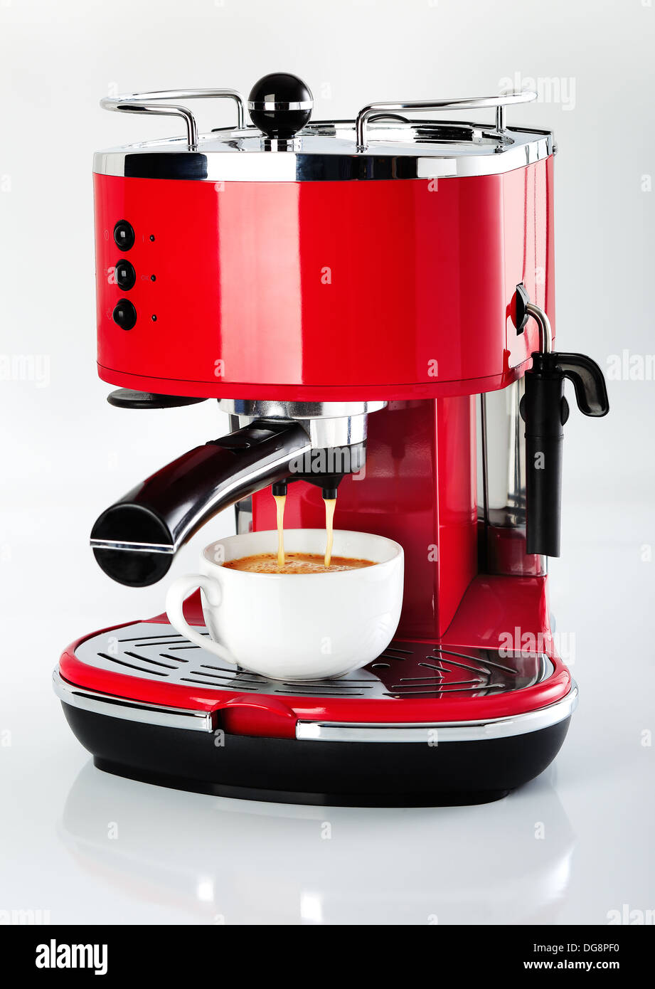 A red vintage looking espresso coffee machine is making a coffee on a ...