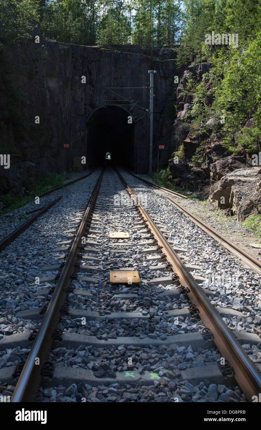 Rails to underground railroad tunnel opening , Finland Stock Photo - Alamy
