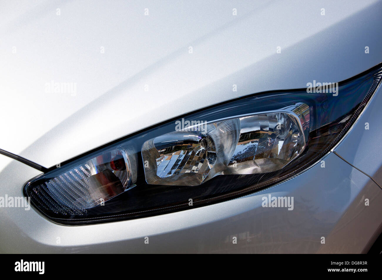 Abstract closeup of vehicle left front head lamp and bonnet Stock Photo ...