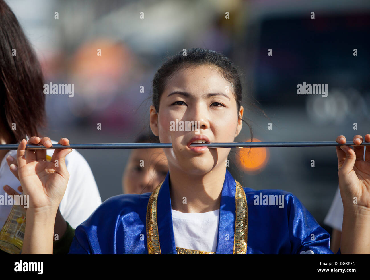 A female Spirit medium walks in a street procession at the Phuket ...