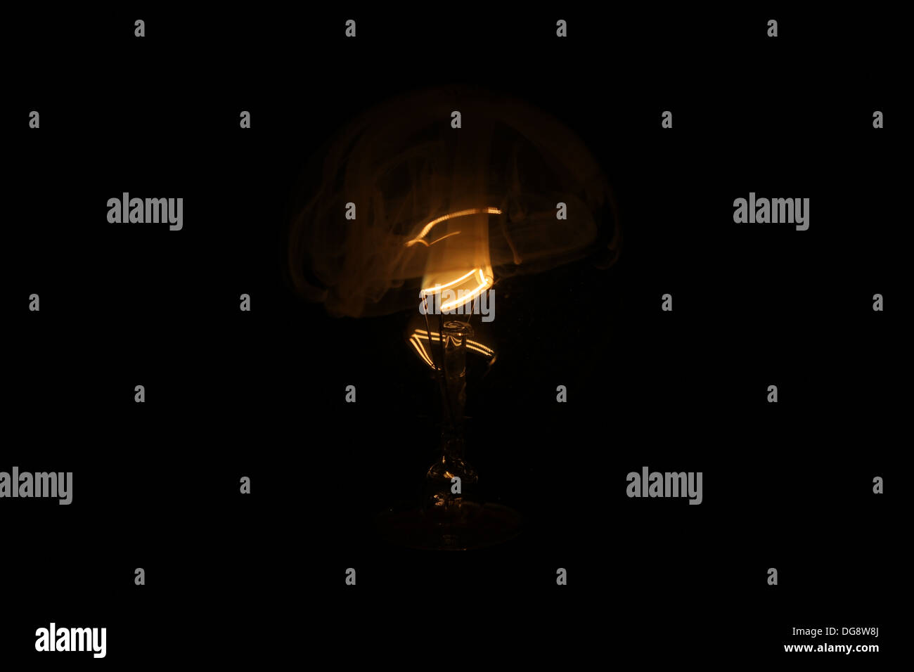 Broken Light bulb blown filament smoking. Image taken with the glass ...