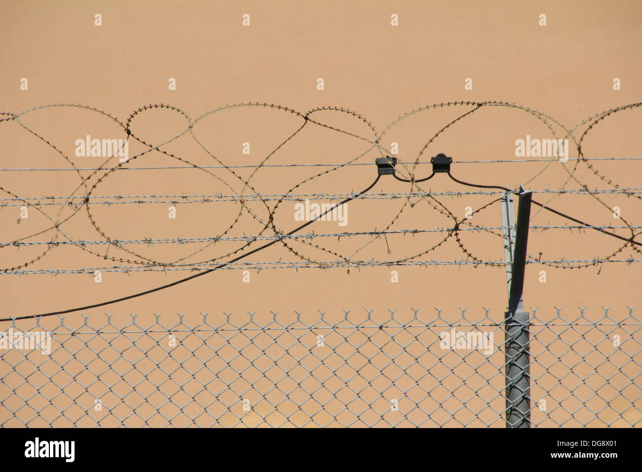 electric security fence by property Stock Photo - Alamy