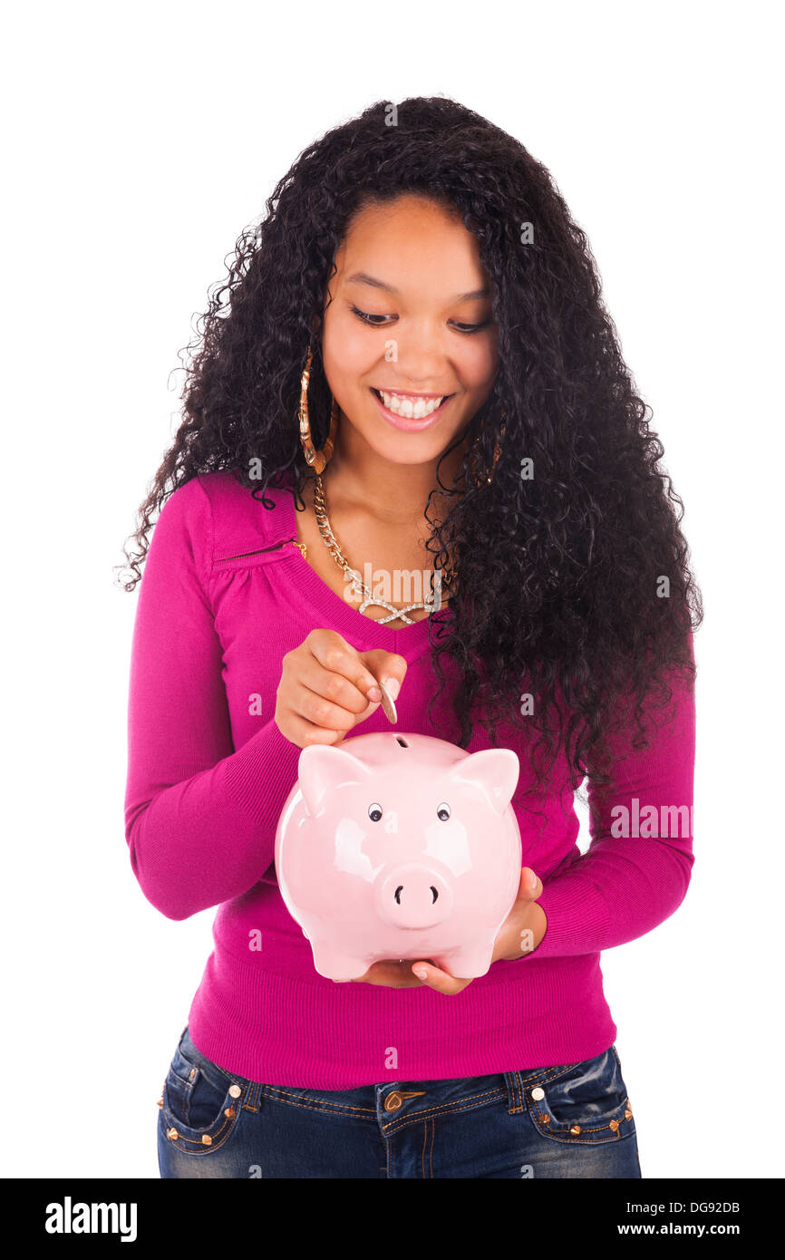 Young african american woman putting coin in piggy bank isolated Stock ...