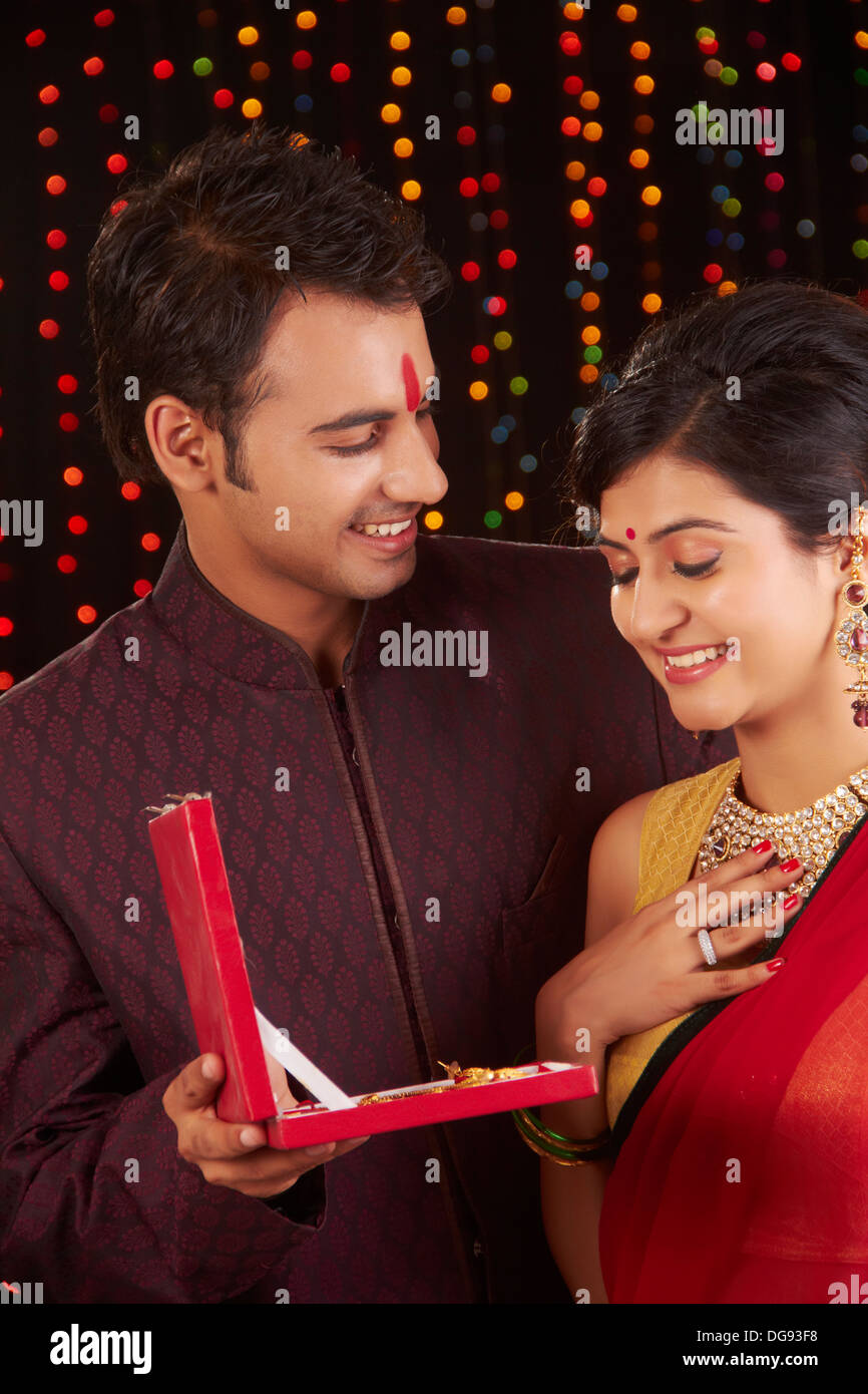 Indian people giving present hi-res stock photography and images - Alamy