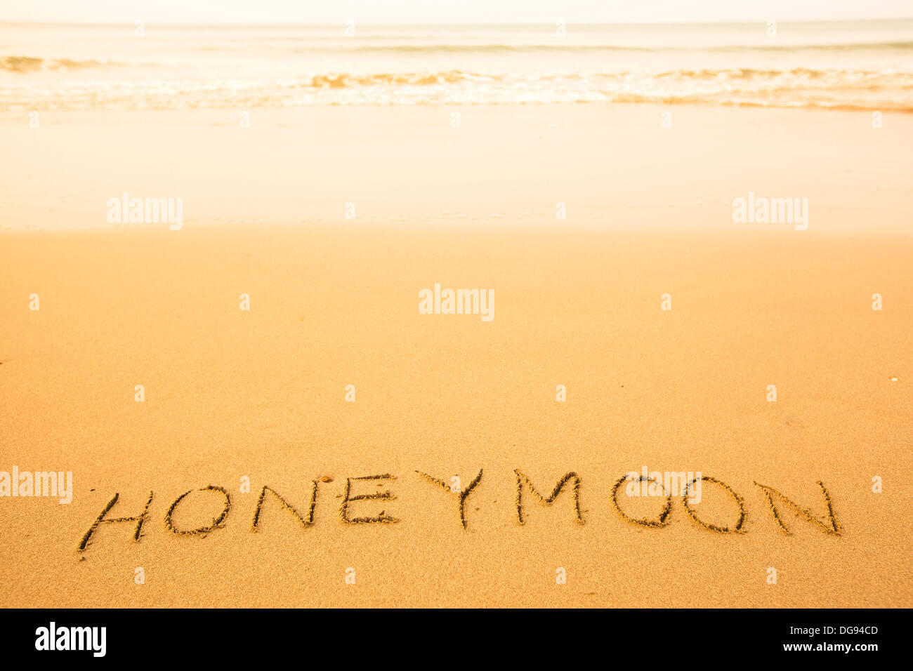 Honeymoon written in sand on hi-res stock photography and images - Alamy