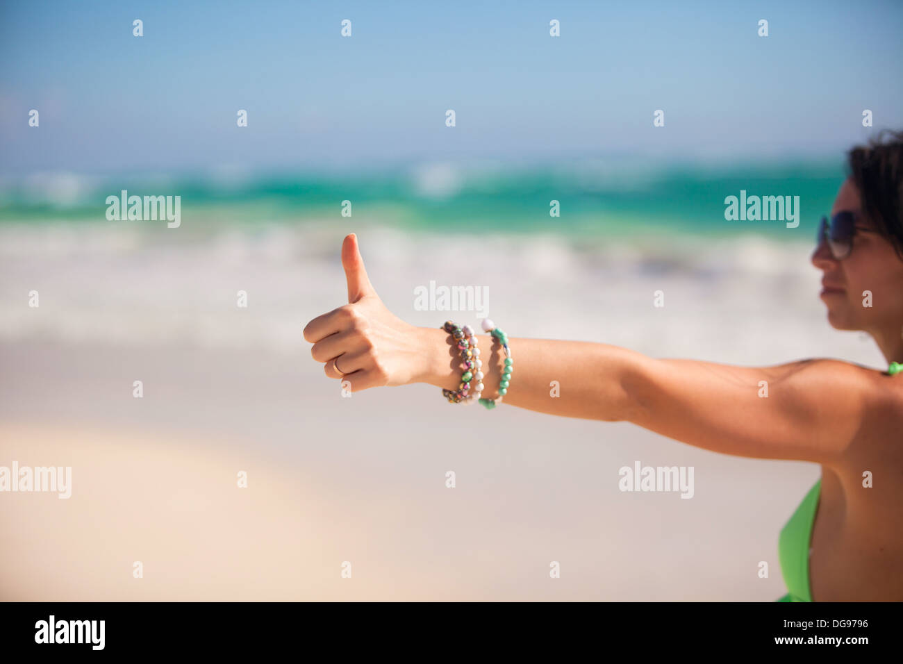 Thumbs up sign on a woman's hand background the turquoise sea Stock ...