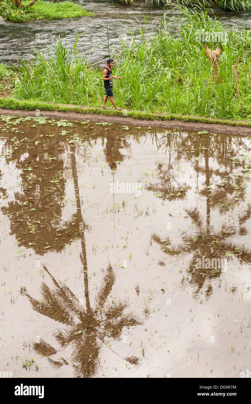 Boy fishing by the Telaga Waja river at Muncan, Eastern Bali, Indonesia ...