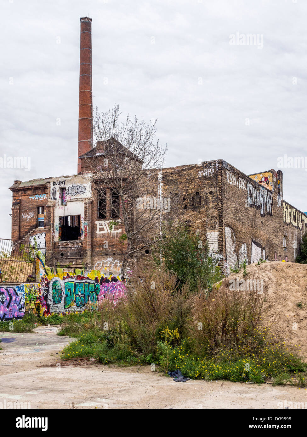 Broken glass windows and graffiti covered brickwork of the abandoned ...