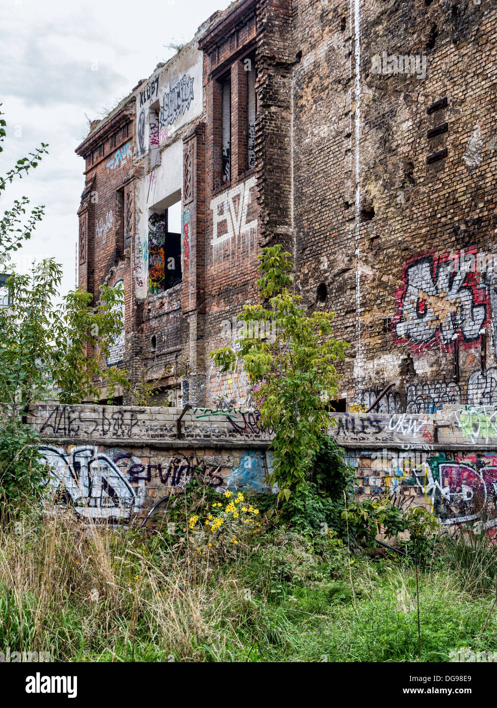 Broken glass windows and graffiti covered brickwork of the abandoned ...