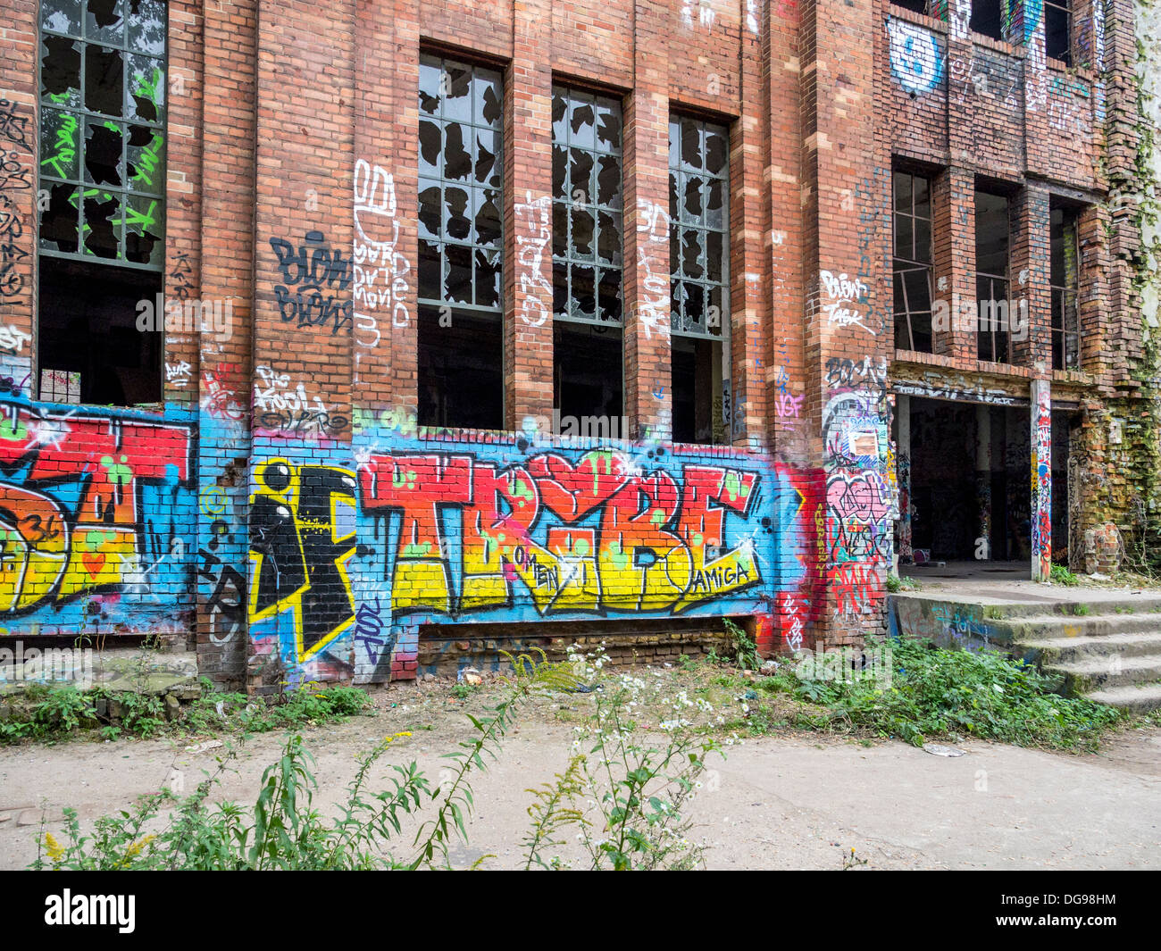 Broken glass windows and graffiti covered brickwork of the abandoned ...
