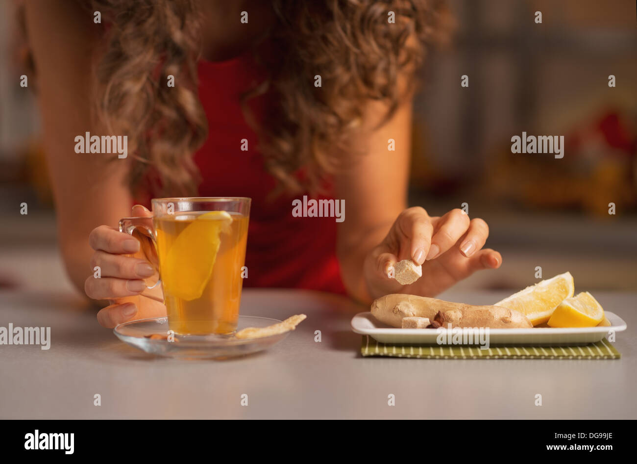 Closeup on young woman adding cane sugar cube in ginger tea Stock Photo ...